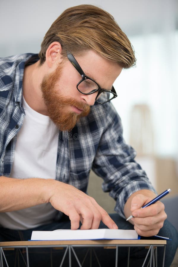 Man writing note on book stock photo. Image of information - 257189262