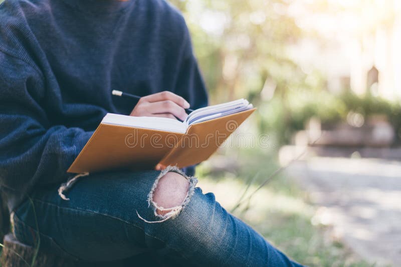 Man Writing a Note in the Park Stock Photo - Image of finger, holding ...