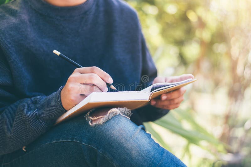 Man Writing a Note in the Park Stock Photo - Image of hobby, business ...