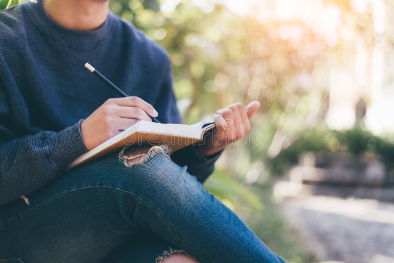 Man Writing a Note in the Park Stock Image - Image of male, jacket ...