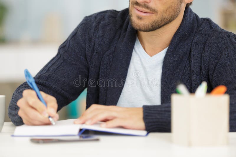 Man Writing Note on Woking Table Stock Image - Image of trilingual ...