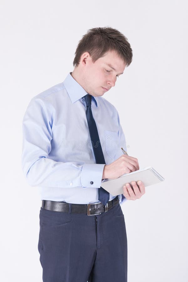 Man writing in a notebook stock photo. Image of looking - 30763394