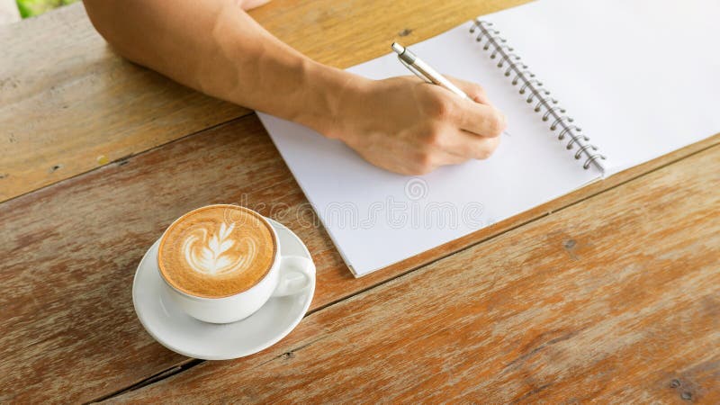 Man Writing on a Notebook in a Cafe Stock Photo - Image of concept ...