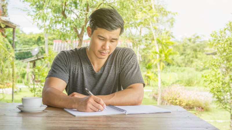 Man Writing on a Notebook in a Cafe Stock Photo - Image of concept ...