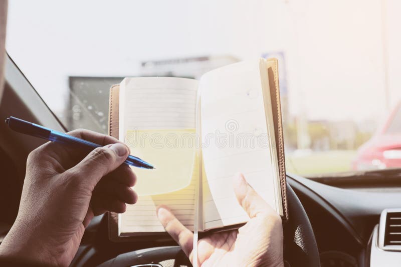 Man Writing Notebook while Driving Car Stock Photo - Image of letter ...