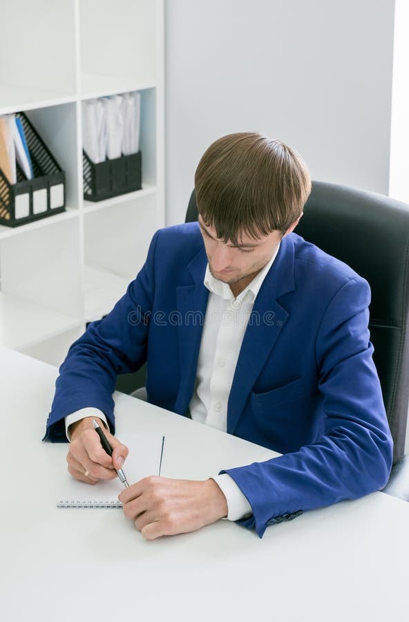Man Writing in a Notebook in the Office Stock Image - Image of ...