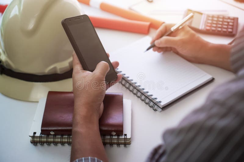 Man Writing on Notepad and Using Phone. Stock Photo - Image of ...