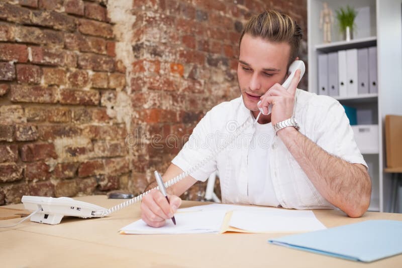 Man Writing Notes while on Call Stock Image - Image of office, business ...
