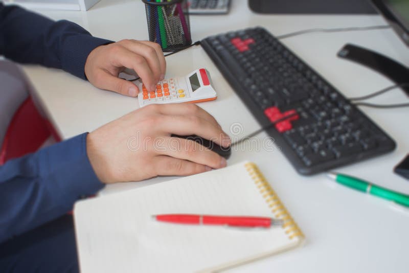Man Writing Notes from Computer on Table. Man Hand with Pen, Calculator ...