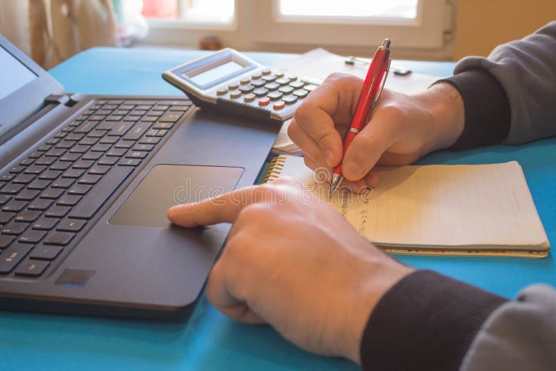 Man Writing Notes from Computer on Table. Man Hand with Pen, Calculator ...