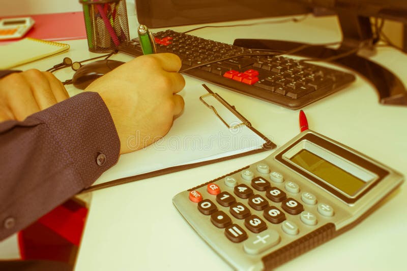 Man Writing Notes from Computer on Wooden Table. Man Hand with Pen ...