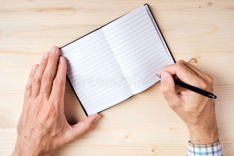 Man Writing Notes in Notebook Stock Photo - Image of notebook, table ...