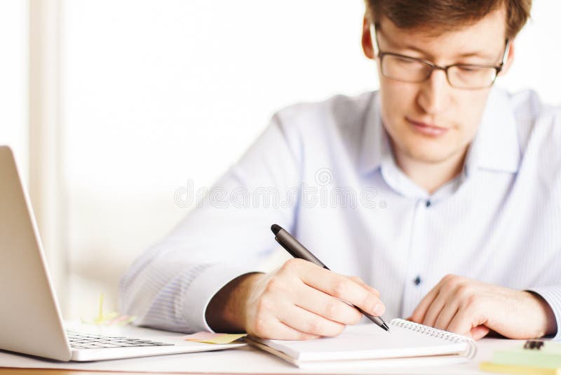 Man writing in office stock image. Image of desktop, notebook - 69668535