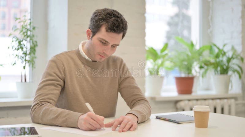 Man Writing on Paper in Office Stock Photo - Image of employee ...