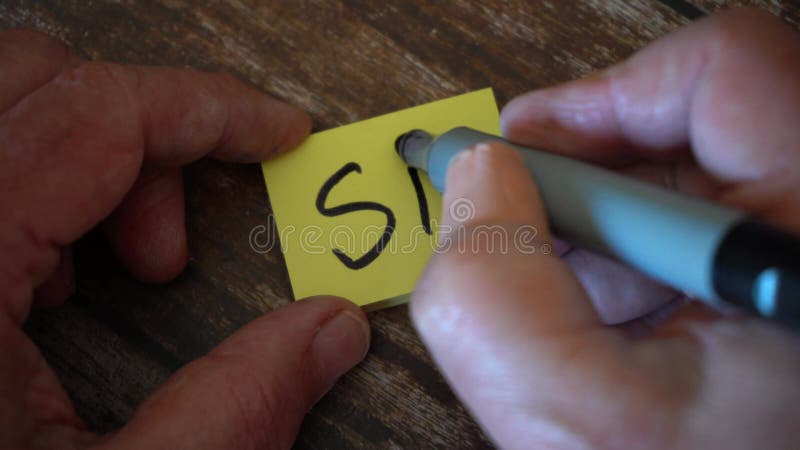 Hand of a Man Writing SI on a Paper or Post-it. Stock Footage - Video ...