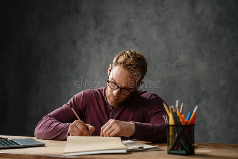 A Man Writing Something in a Diary in the Studio Stock Image - Image of ...