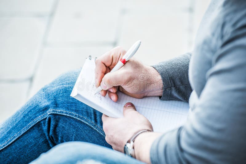 Man Writing Something on a Notebook - Side View Stock Photo - Image of ...