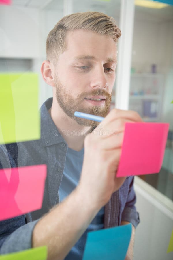 Man Writing at Sticky Notes on Window Stock Photo - Image of male ... Man Writing at Sticky Notes on Window Stock Photo - Image of male ...