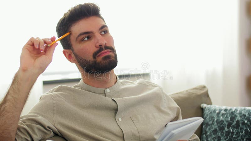 Man Writing To Notebook and Thinking at Home Stock Footage - Video of ...