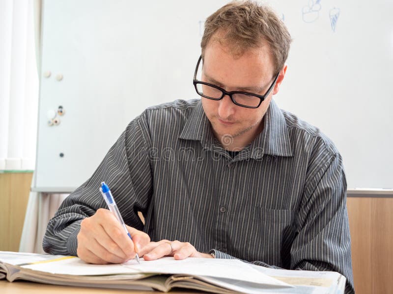A Man Writing Up Paperwork at Work. Stock Photo - Image of admin ...
