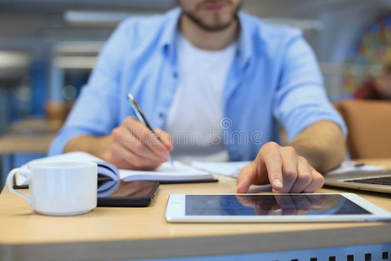 Man Writing Work Plan with Pen on Paper Notebook, Browsing Internet on ...