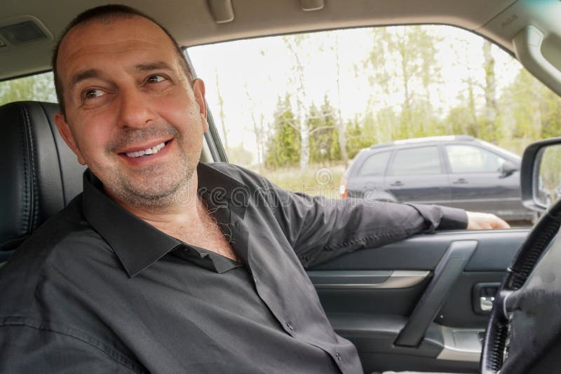 Man 50 Years Old in a Black Shirt Driving a Car Stock Photo - Image of ...