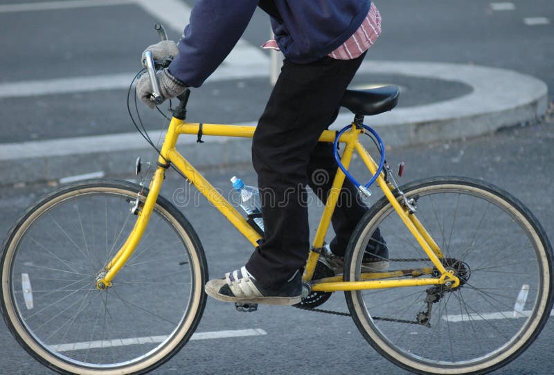 Man on yellow bicycle stock image. Image of helmet, road - 523379