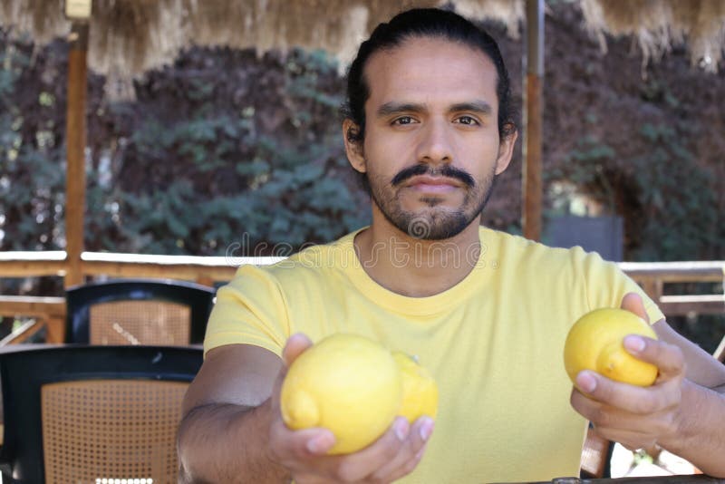 Man in Yellow Holding Lemons Stock Photo - Image of arabic, acidity ...