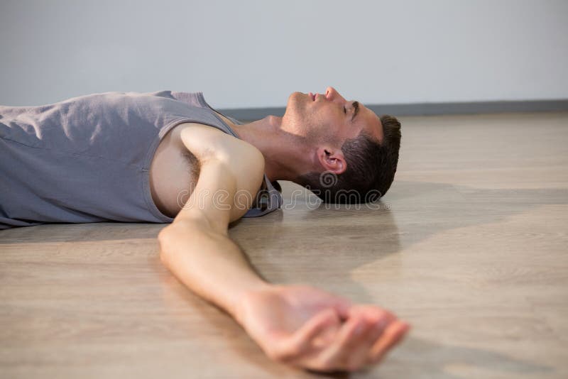 Man in yoga corpse pose stock photo. Image of floor, exercising - 78652558