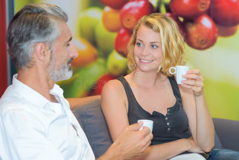 Man and Young Lady Drinking Coffee Stock Image - Image of colleagues ...