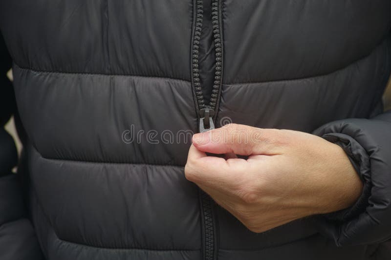 A Man Zipping Up His Puffer Jacket Stock Photo - Image of jacket ...