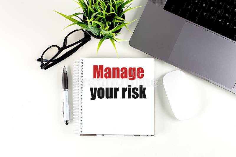 MANAGE YOUR RISK Text on Notebook with Laptop, Mouse and Pen Stock ...
