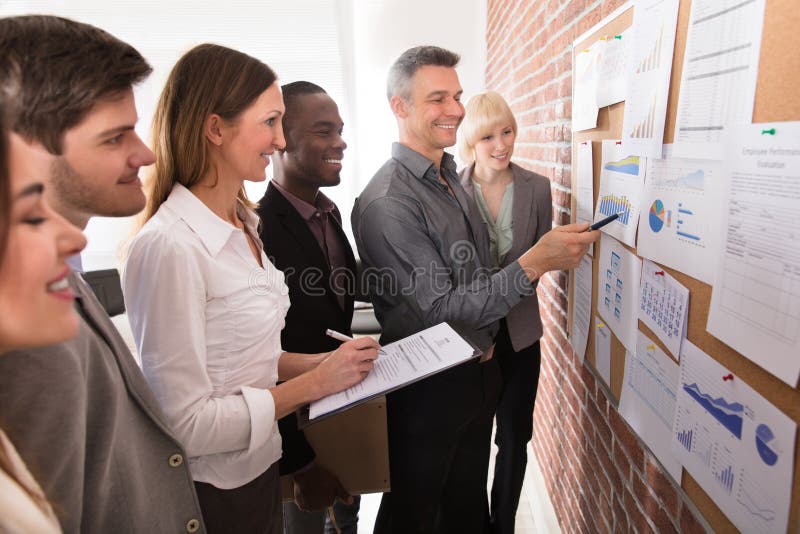 Manager Analyzing the Graph with His Colleague Stock Image - Image of ...