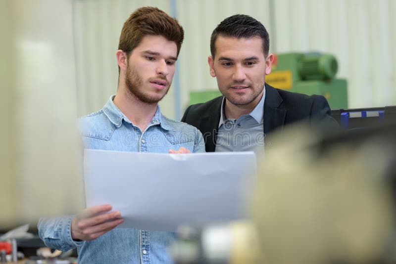 Manager and Apprentice with Factory Plans Stock Photo - Image of adult ...