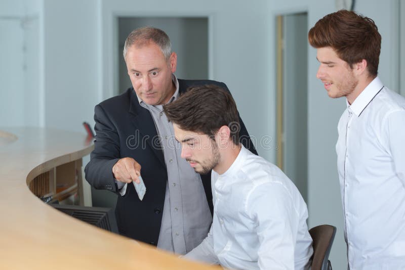 Manager with Apprentices in Hotel Reception Stock Image - Image of ...
