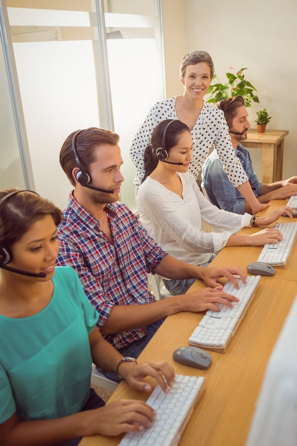 Manager Assisting Staffs in Call Center Stock Image - Image of computer ...