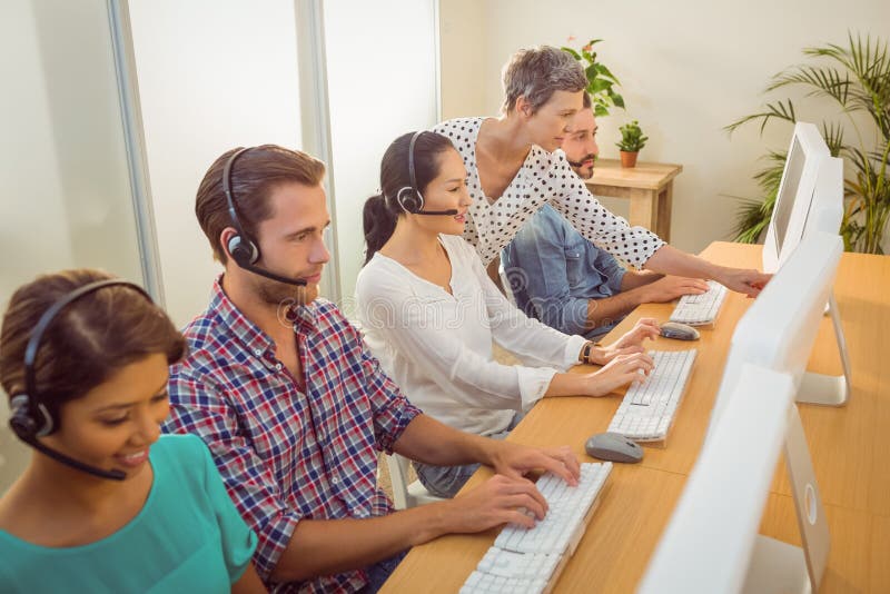 Smiling Call Center Employees Sitting in Line Stock Photo - Image of ...
