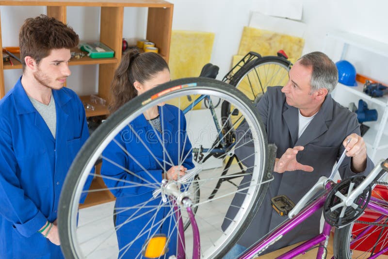 Manager Bike Shop Showing Mechanics Apprentice in Workshop Stock Photo ...