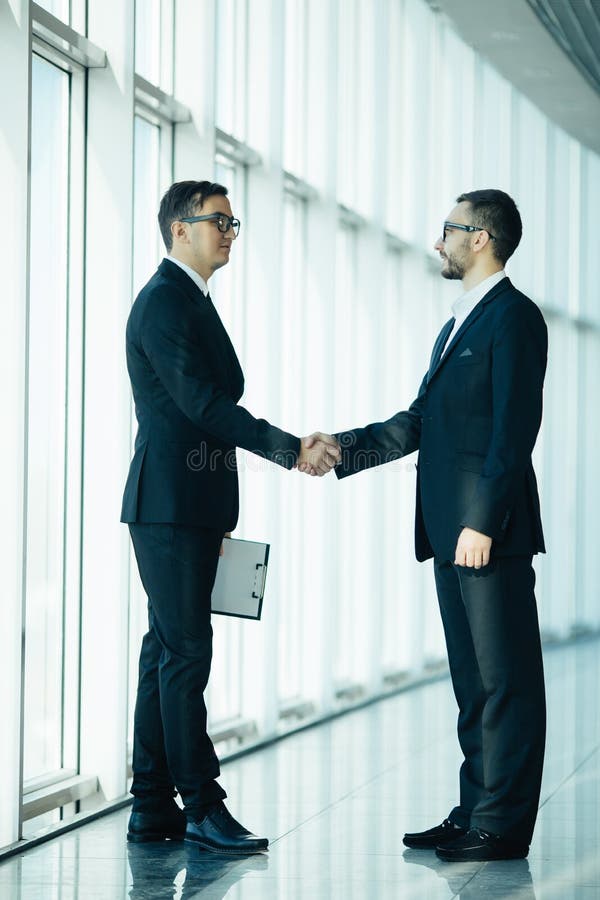 Manager and boss handshake stock photo. Image of hall - 83643594
