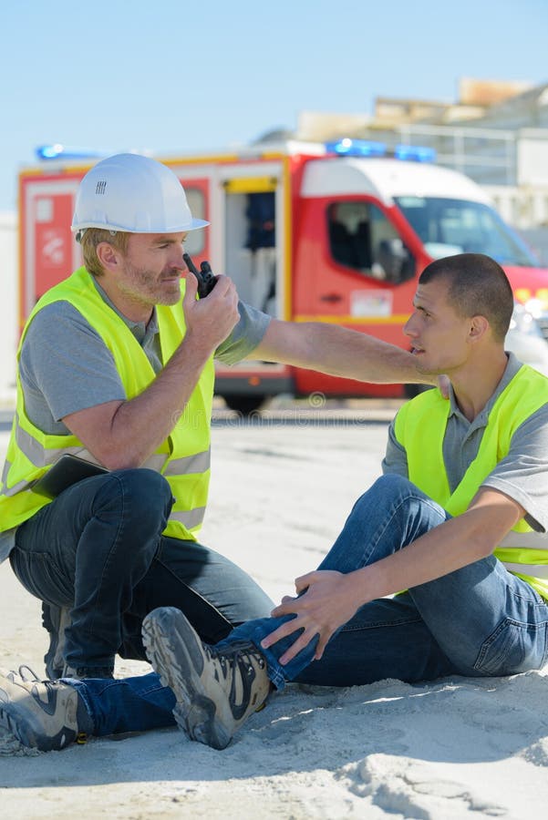 Manager Calling for Help for Construction Worker Injured at Work Stock ...