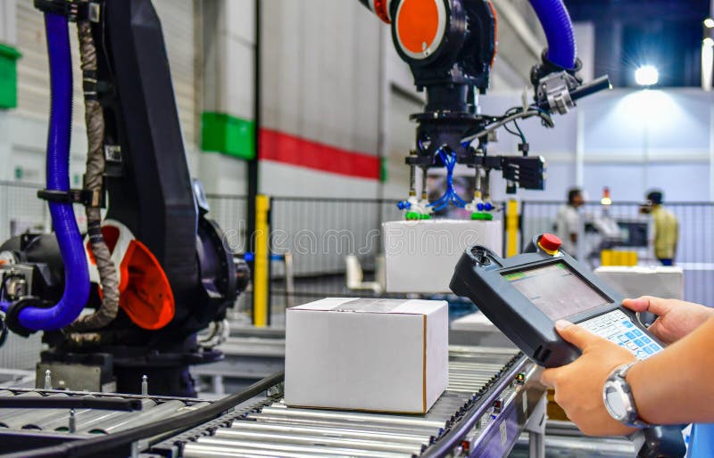 Manager Check and Control Automation Robot Arms Holding a White Box and ...