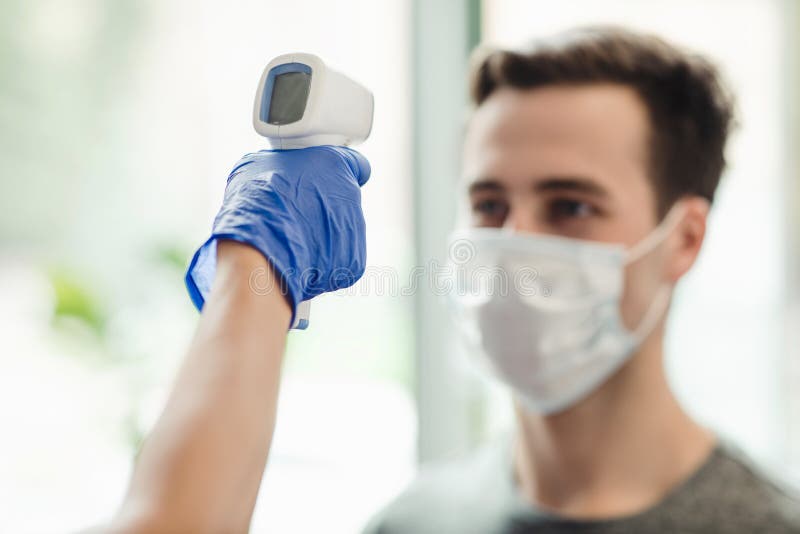 Manager Checking Body Temperature of Man with Contactless Thermometer ...