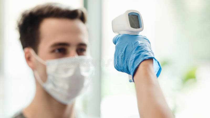 Manager Checking Body Temperature of Man with Contactless Thermometer ...