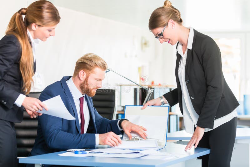 Manager Checking Documents in Front of Assistants Stock Image - Image ...