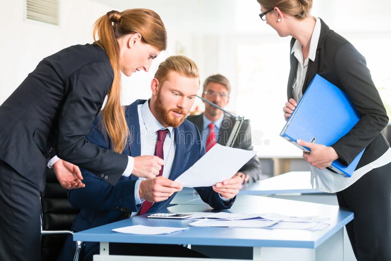 Manager Checking Documents in Front of Assistants Stock Image - Image ...