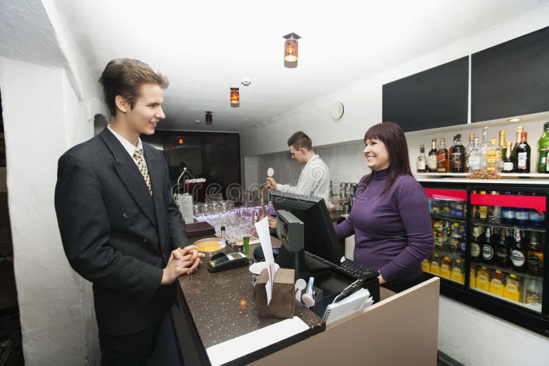 Portrait of Bartender with Cashier at Counter in Restaurant Stock Image ...