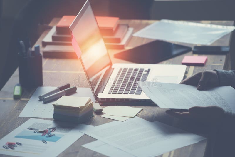 Manager with Computer and Paperwork Sitting at His Desk in Office ...