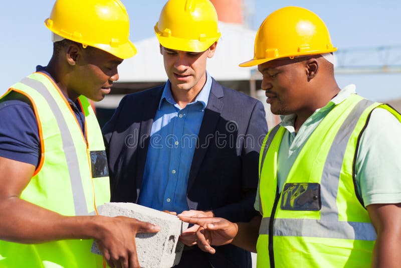 Construction Co-workers Discussing Stock Image - Image of blue, male ...
