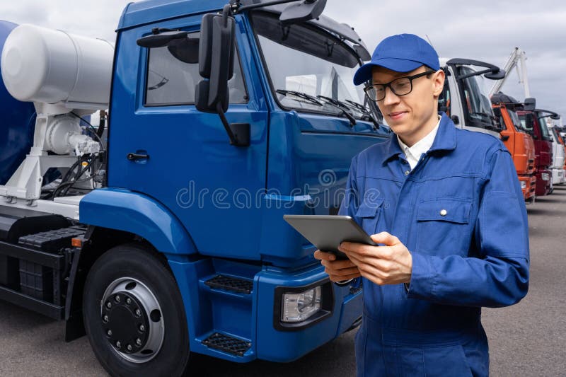Manager with a Digital Tablet Next To Trucks. Stock Image - Image of ...