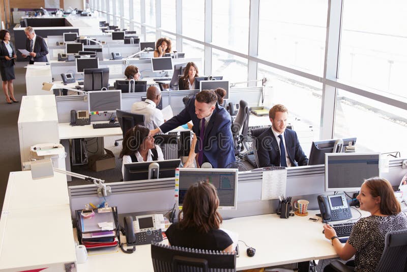 Manager in Discussion with Coworker in an Open Plan Office Stock Photo ...